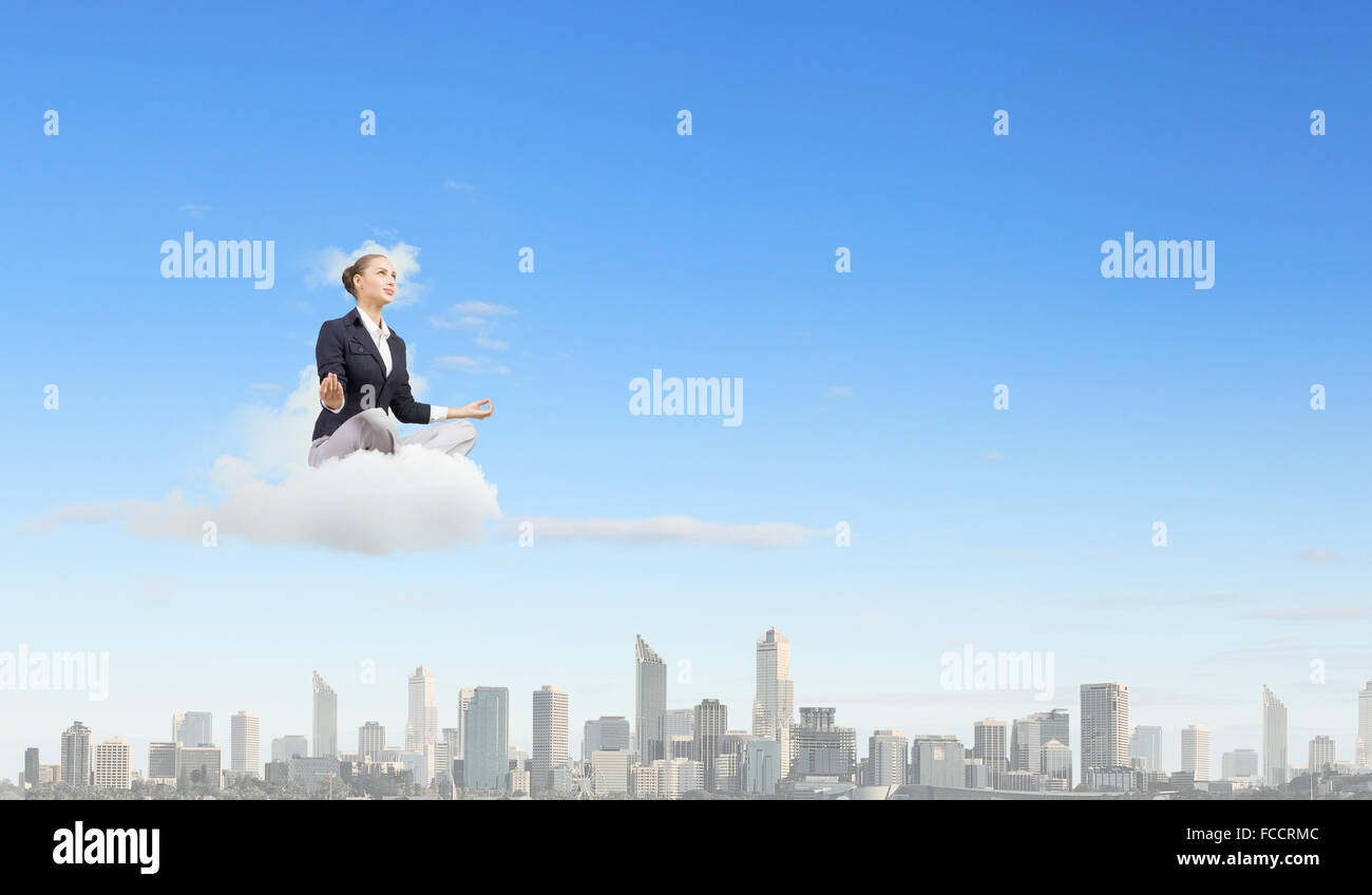 Young attractive woman sitting on cloud and meditating Stock Photo - Alamy