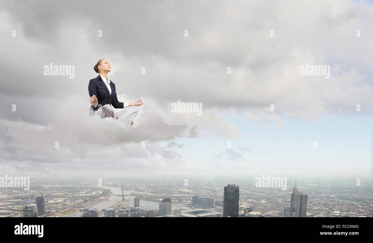 Young attractive woman sitting on cloud and meditating Stock Photo - Alamy