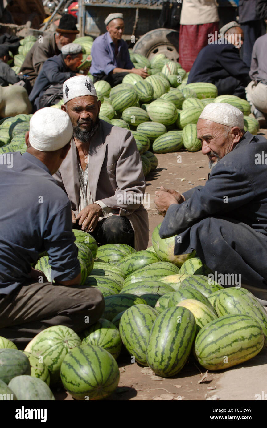 Uyghur men selling watermelons in traditional Sunday Market in Kashgar ...
