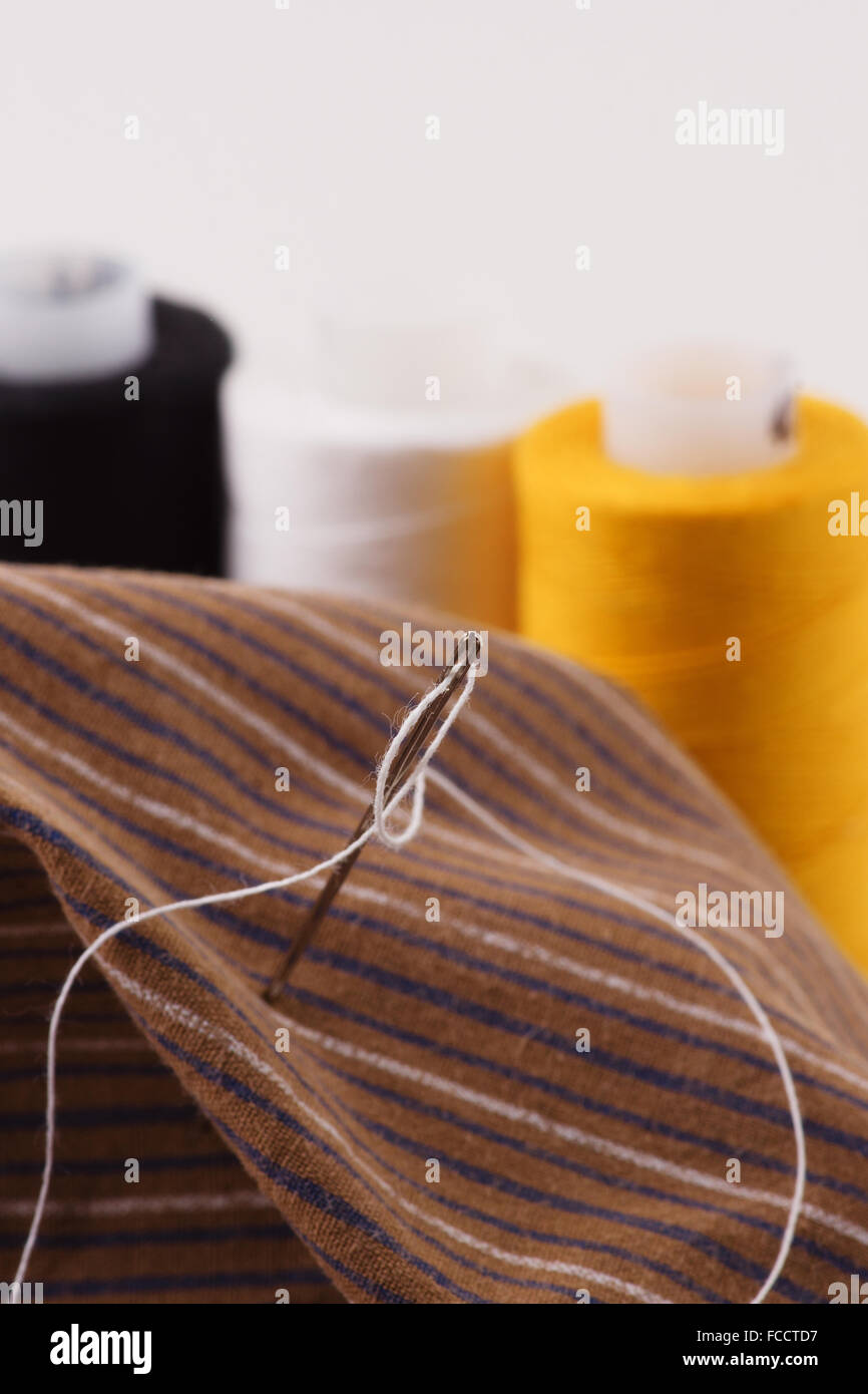 we sew buttons a sharp needle with a thread Stock Photo - Alamy