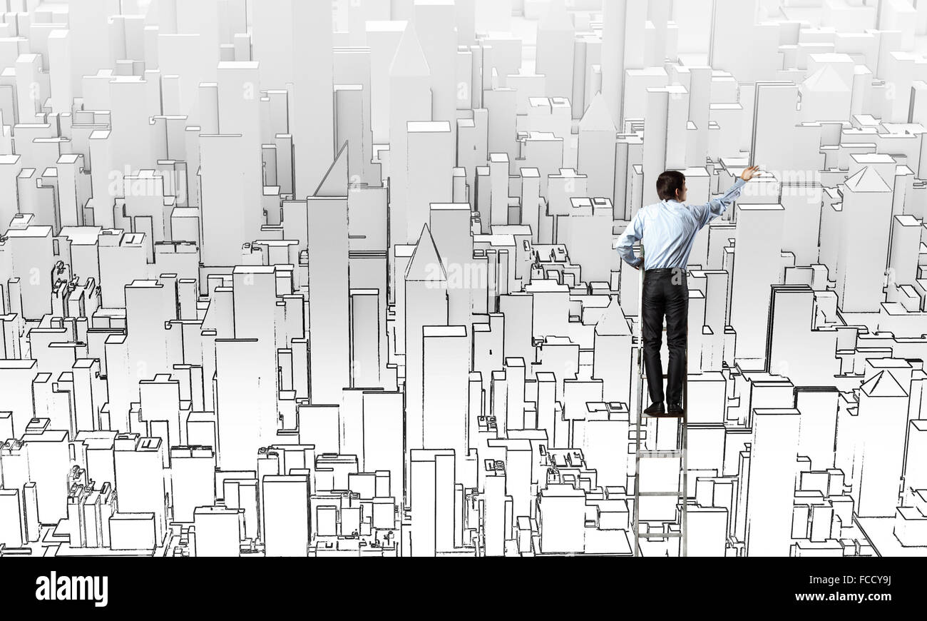 Back view of businessman standing on ladder and drawing buildings Stock ...
