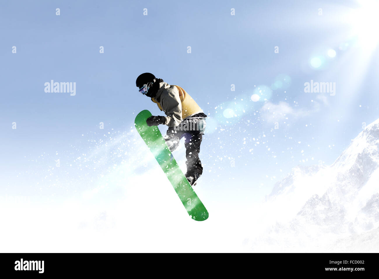 Snowboarder making jump high in clear sky Stock Photo - Alamy