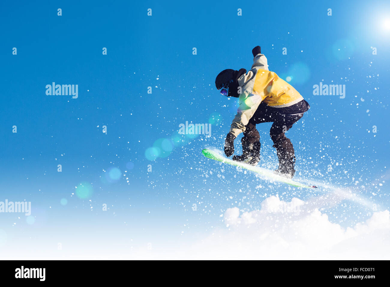 Snowboarder making jump high in clear sky Stock Photo - Alamy