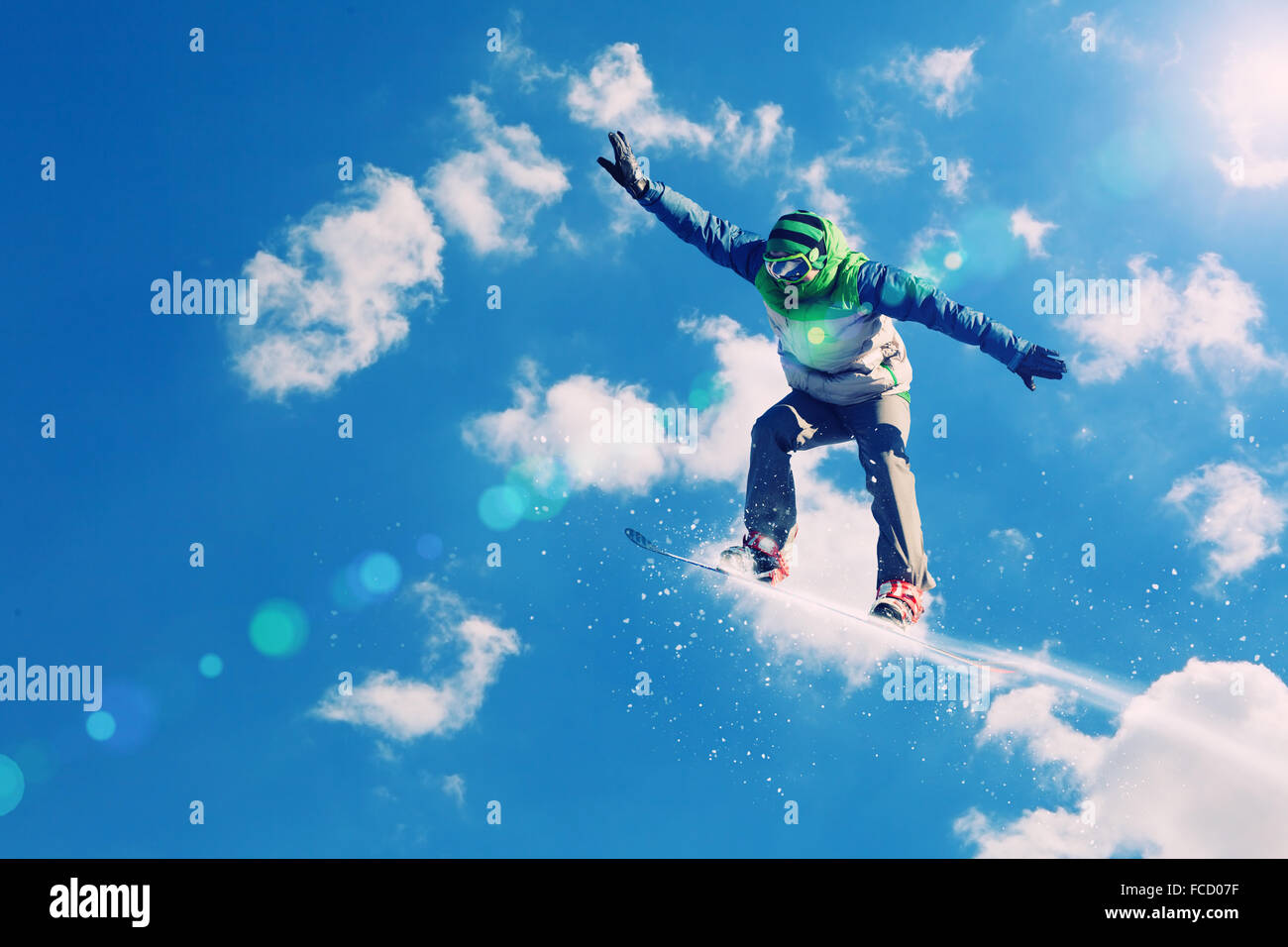 Snowboarder making jump high in clear sky Stock Photo - Alamy