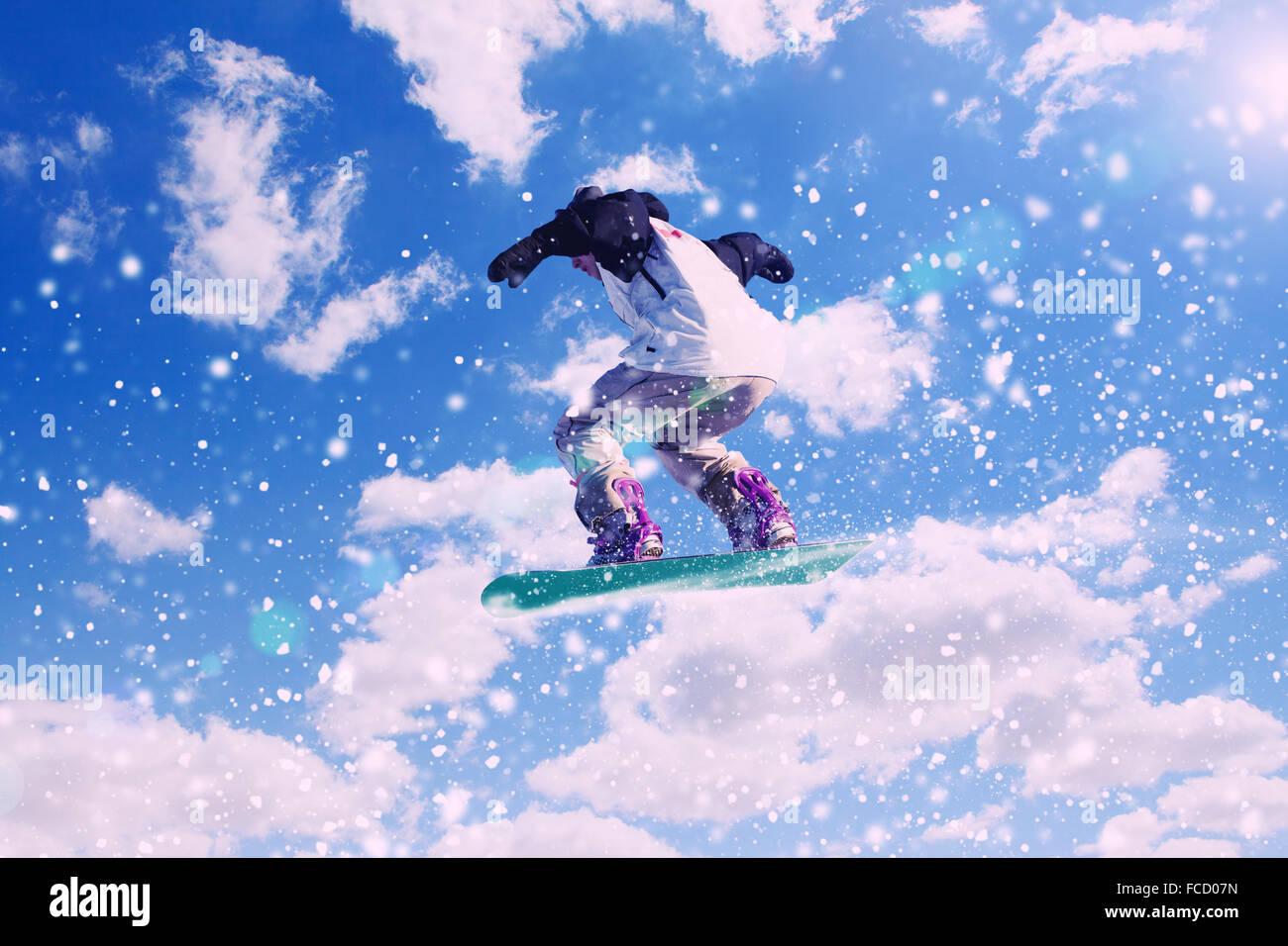 Snowboarder making jump high in clear sky Stock Photo - Alamy