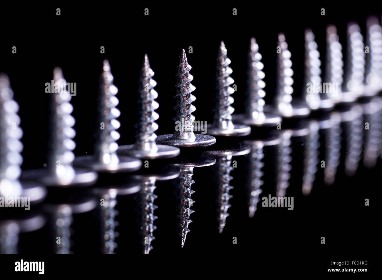 Screws diagonal row Stock Photo - Alamy