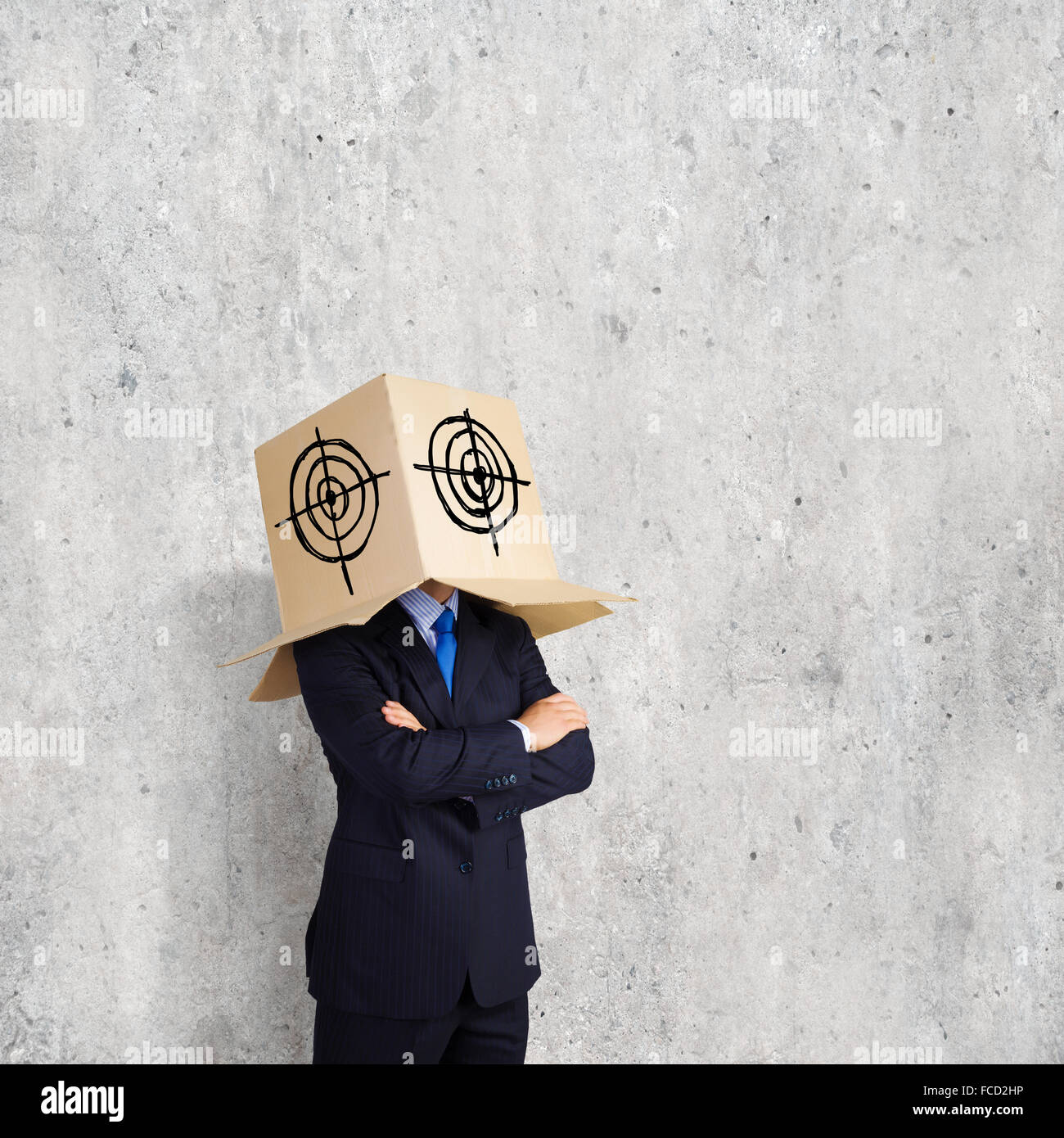 Man wearing carton box with target on head Stock Photo - Alamy