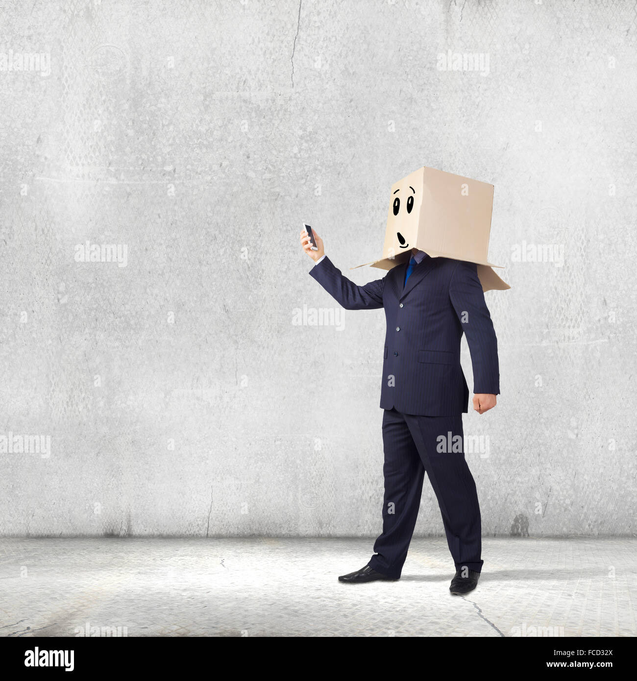 Businessman using mobile phone wearing carton box on head Stock Photo ...