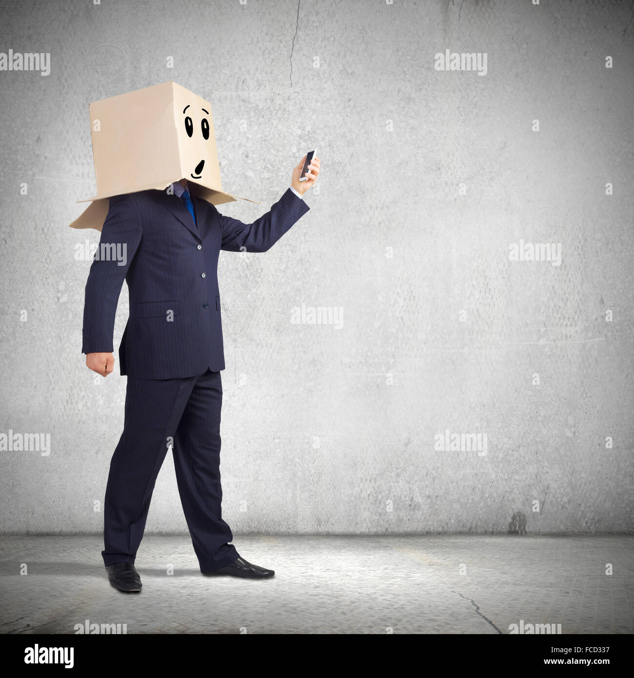 Businessman using mobile phone wearing carton box on head Stock Photo ...
