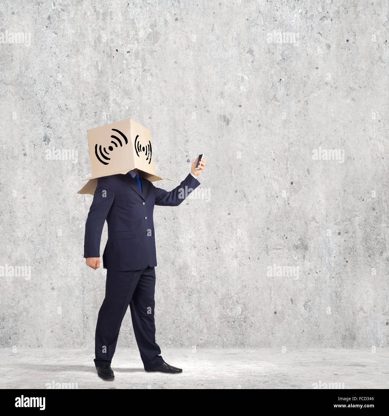 Businessman using mobile phone wearing carton box on head Stock Photo ...
