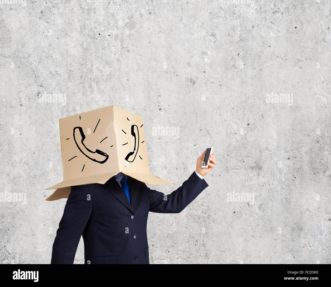 Businessman using mobile phone wearing carton box on head Stock Photo ...