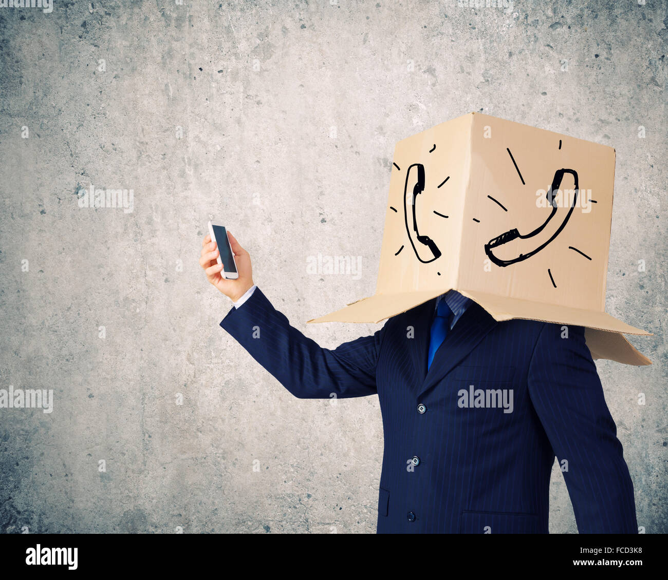 Businessman using mobile phone wearing carton box on head Stock Photo ...