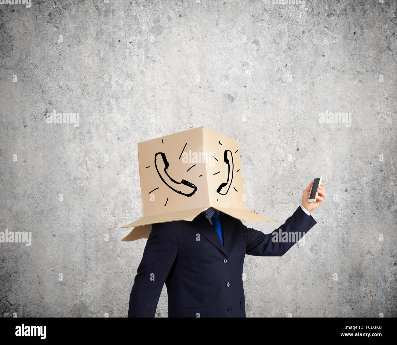 Businessman using mobile phone wearing carton box on head Stock Photo ...