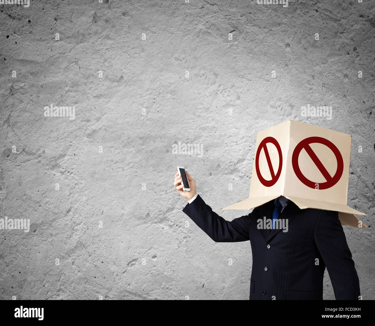 Businessman using mobile phone wearing carton box on head Stock Photo ...