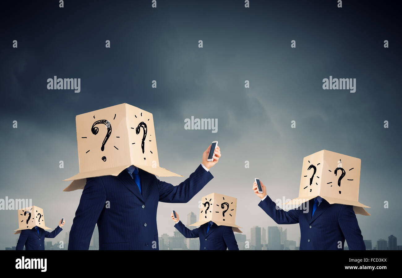 Businessman using mobile phone wearing carton box on head Stock Photo ...