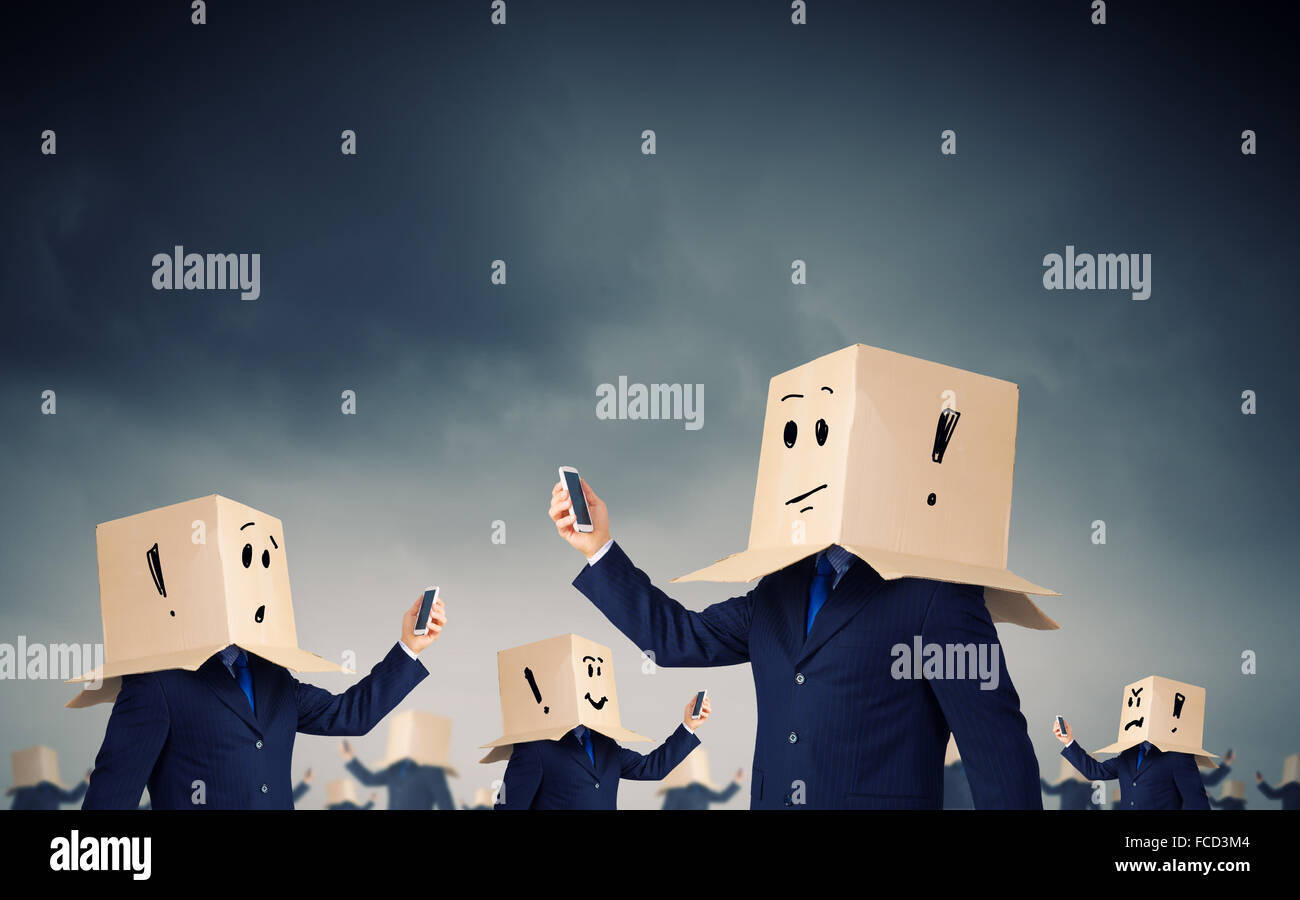 Businessman using mobile phone wearing carton box on head Stock Photo ...