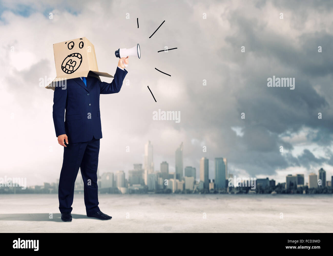 Businessman wearing box on head screaming in to megaphone hi-res stock ...