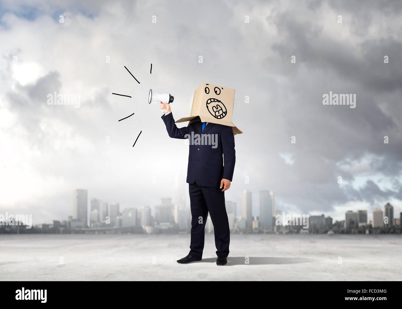 Businessman wearing box on head screaming in to megaphone hi-res stock ...