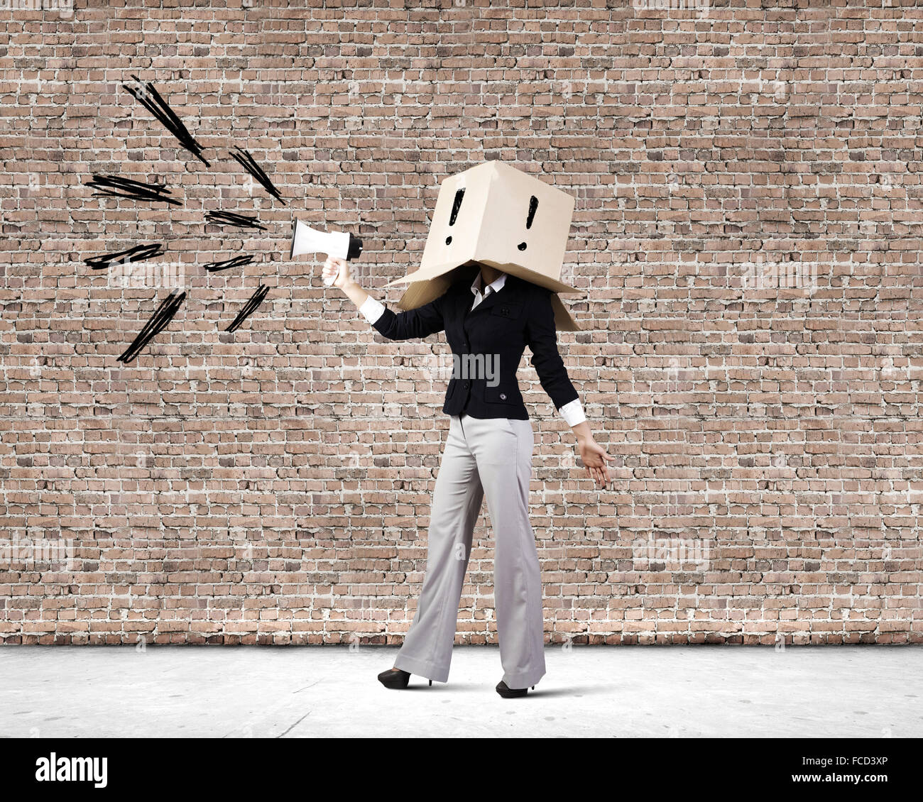 Businesswoman wearing carton box on head and speaking in megaphone ...