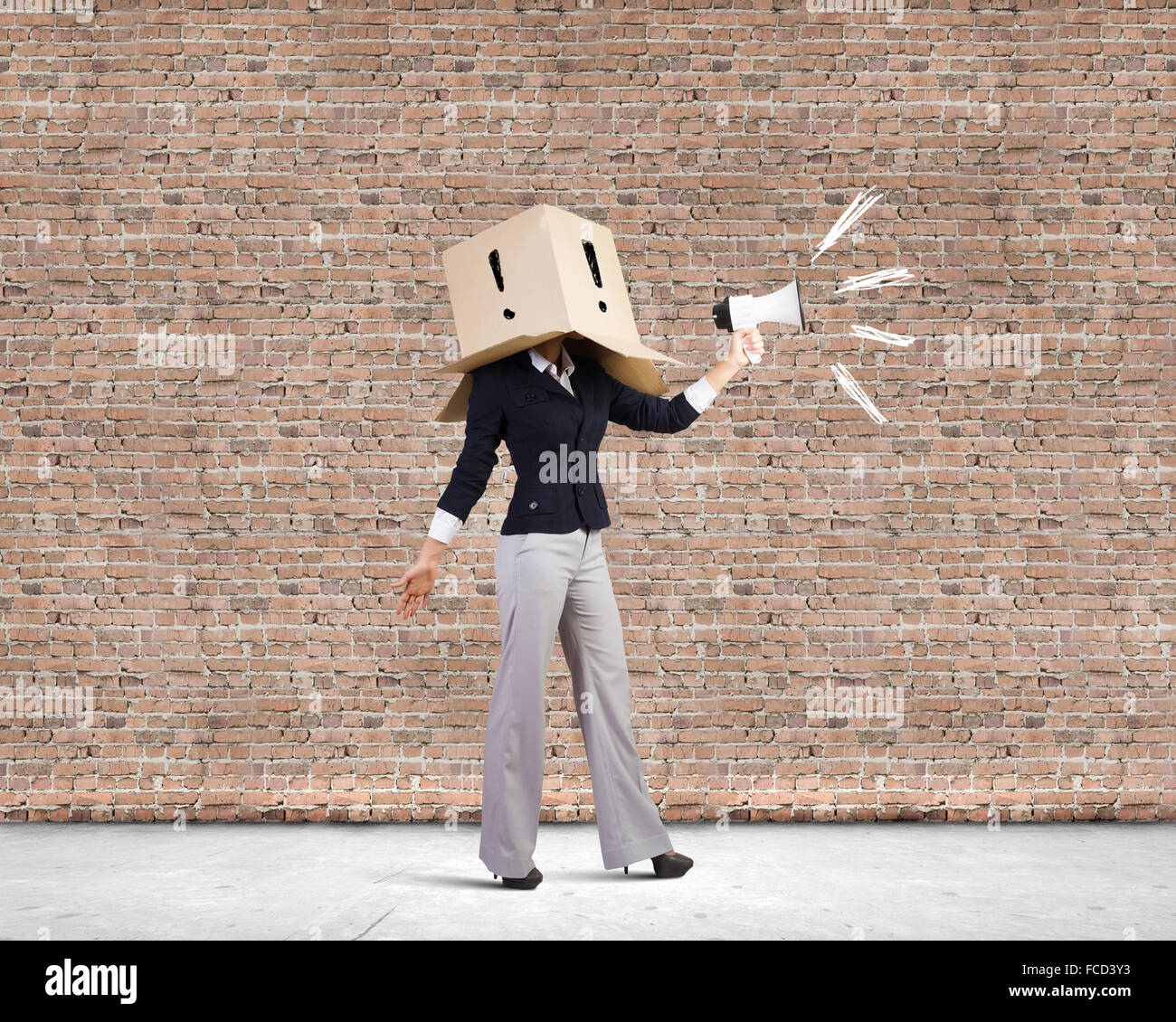 Businesswoman wearing carton box on head and speaking in megaphone ...