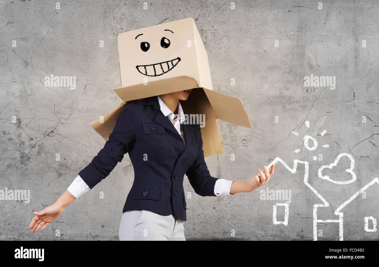 Confident businesswoman wearing carton box on head Stock Photo - Alamy