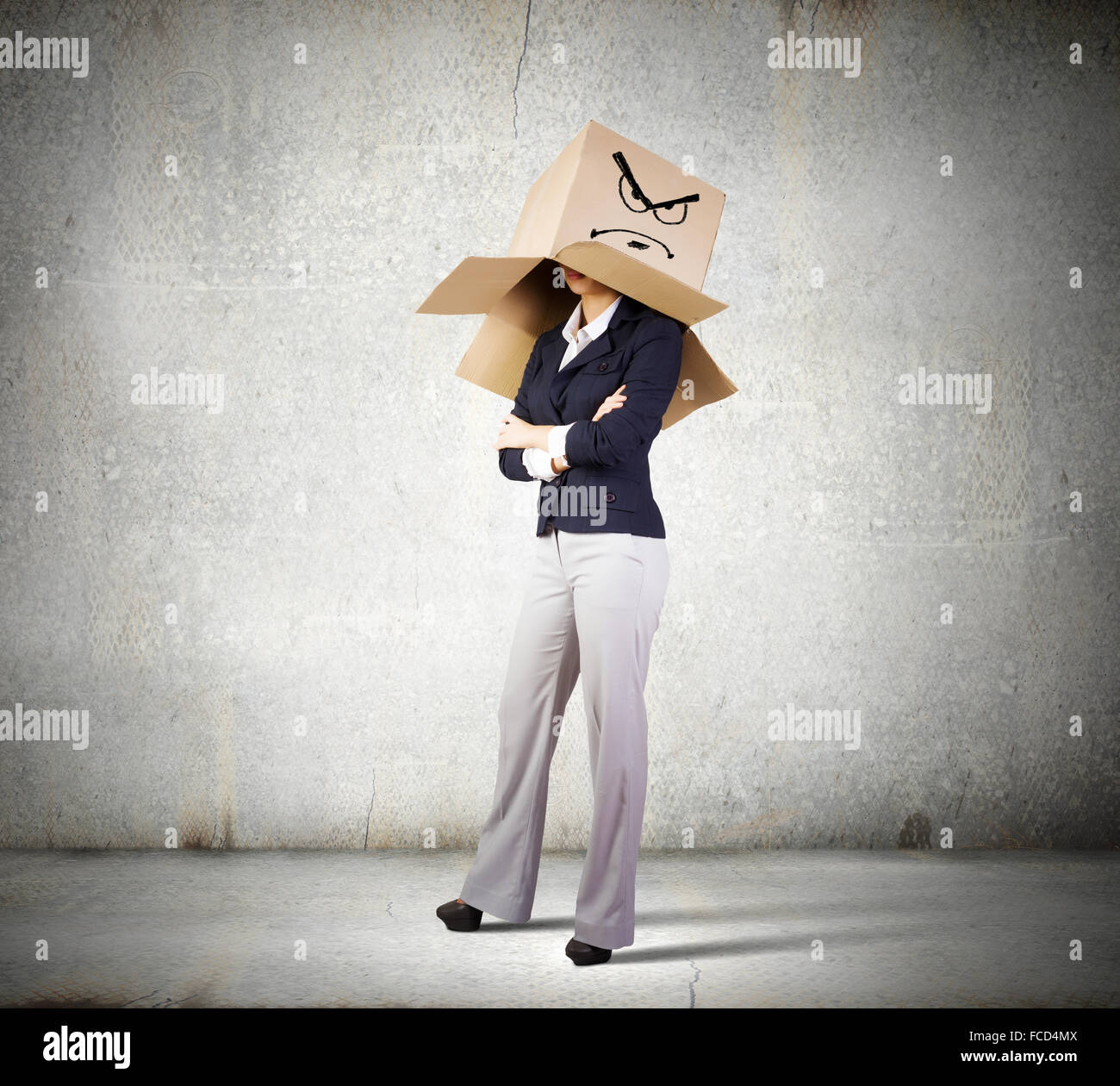 Businesswoman in suit wearing carton box on head Stock Photo - Alamy