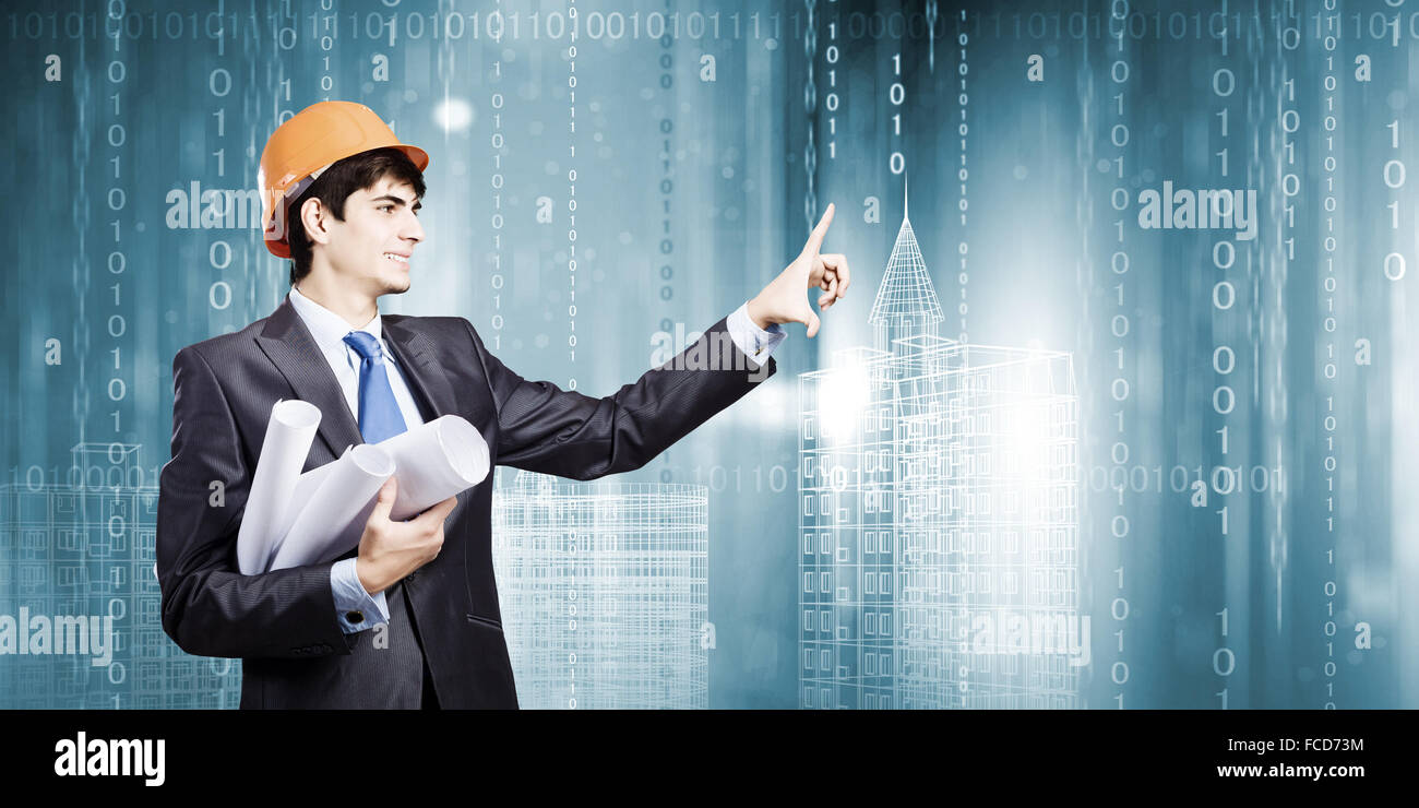 Young man engineer in helmet touching icon of media screen Stock Photo ...