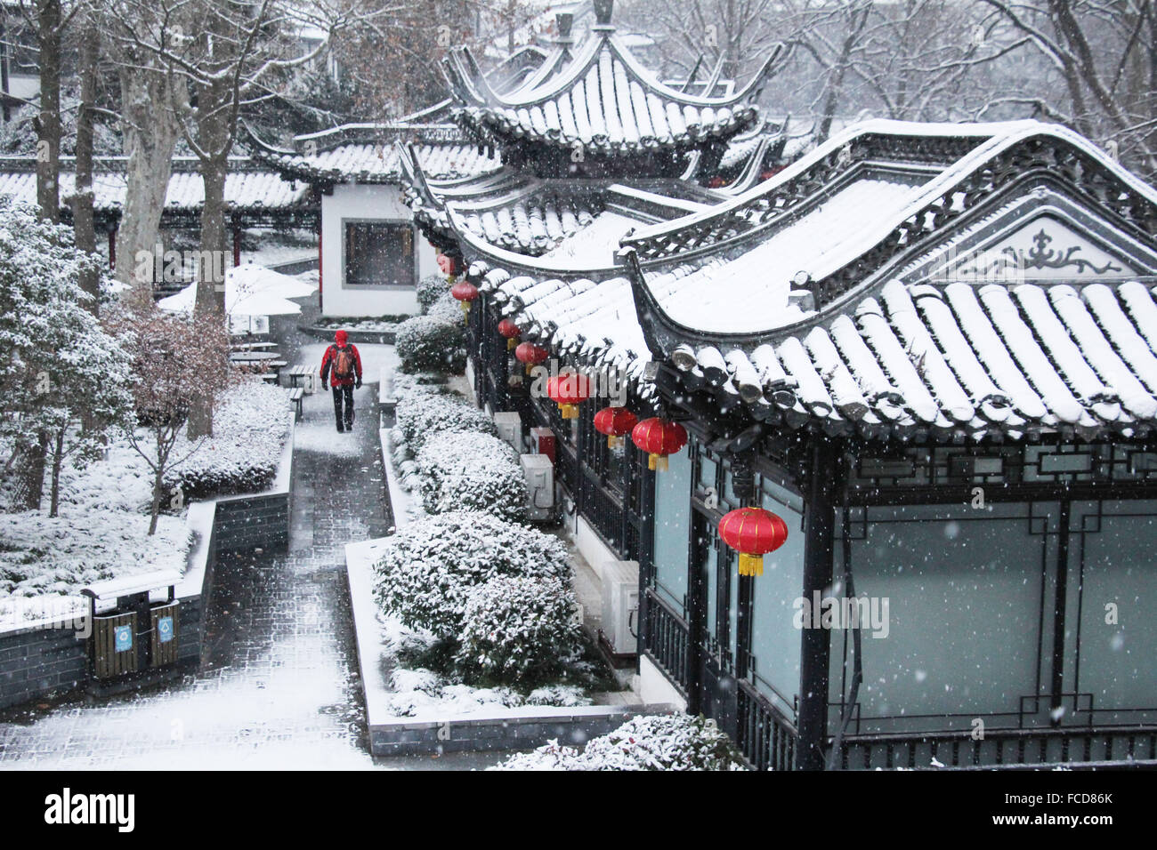 Yangzhou, China's Jiangsu Province. 21st Jan, 2016. A man walks in snow ...