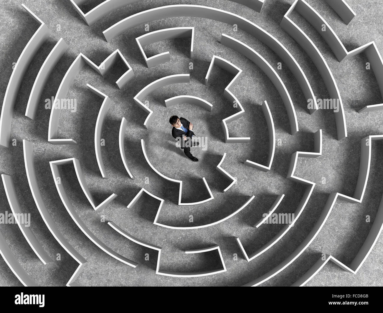 Top view of successful businessman standing in center of labyrinth ...