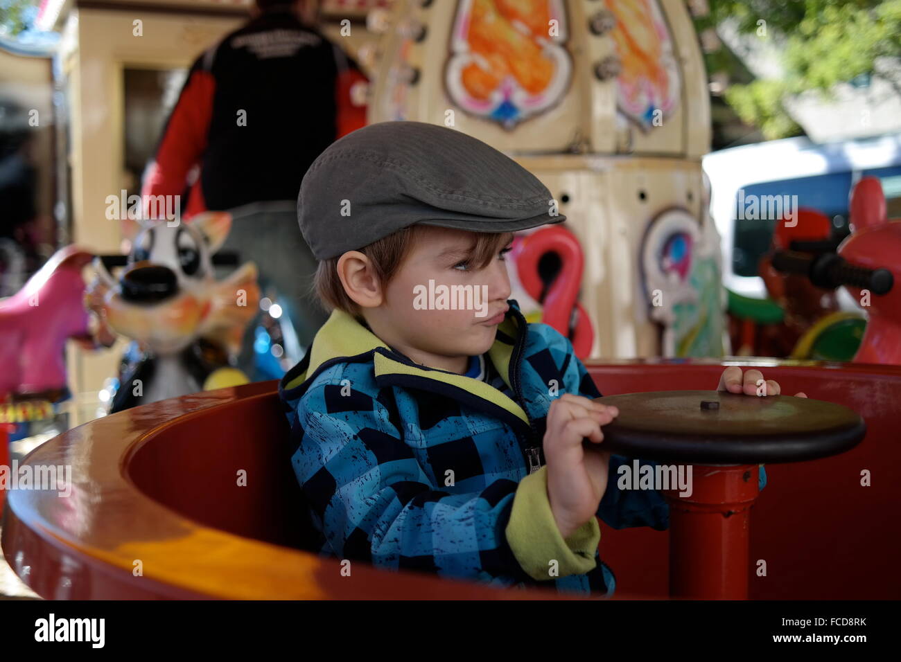 Boy Enjoying Amusement Park Ride Stock Photo - Alamy