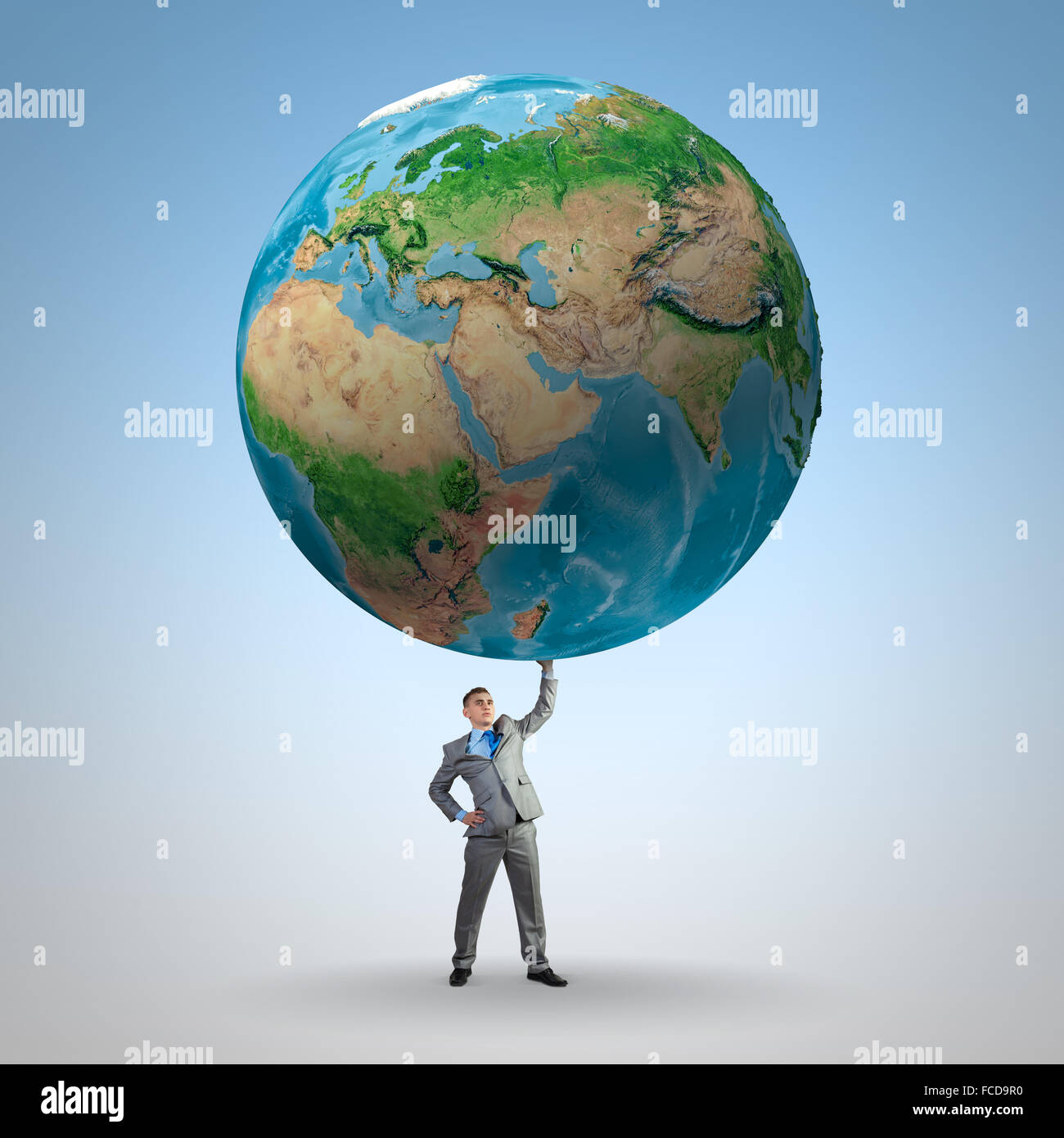 Businessman holding huge Earth planet above head. Elements of this ...