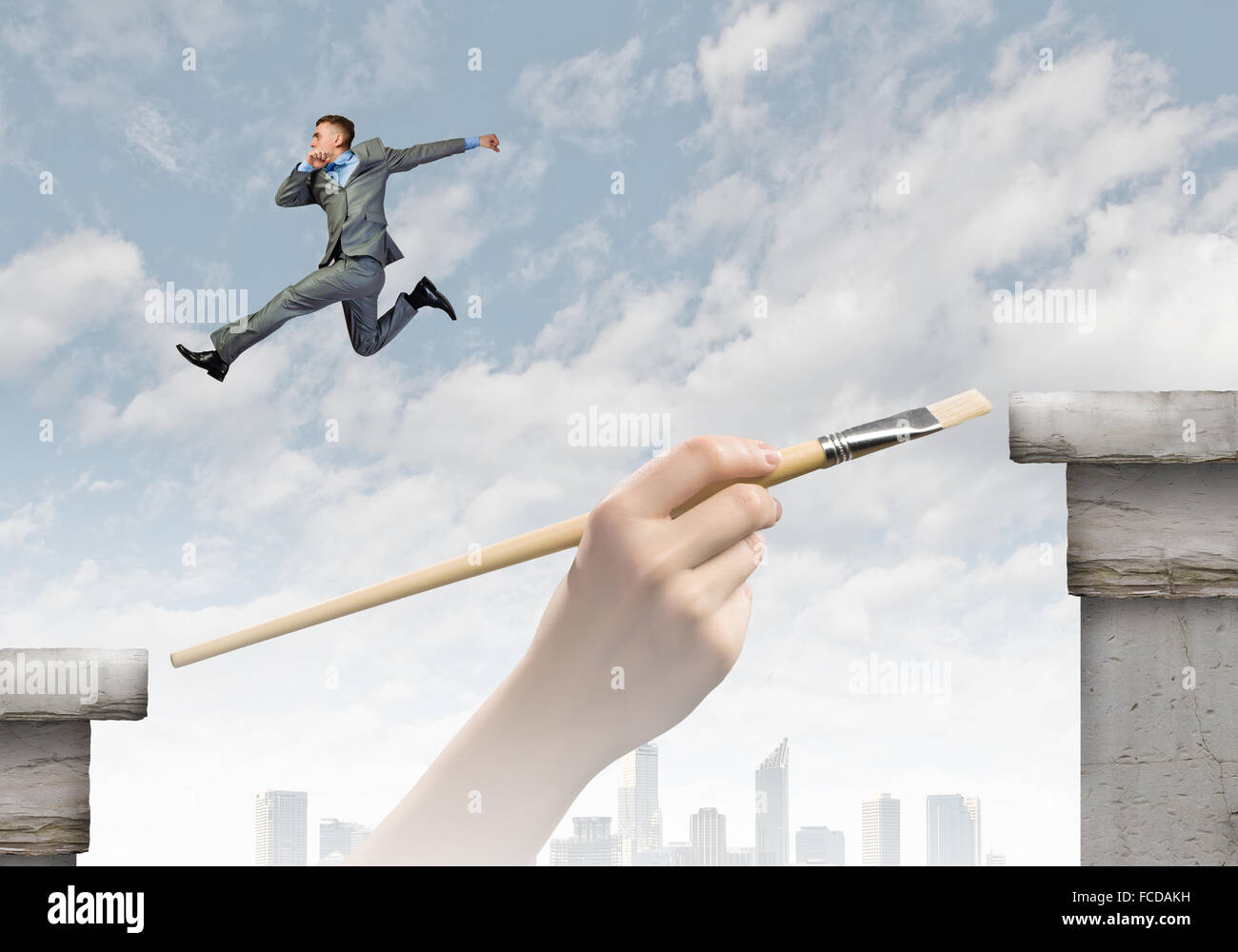 Young businessman jumping over gap. Risk concept Stock Photo - Alamy