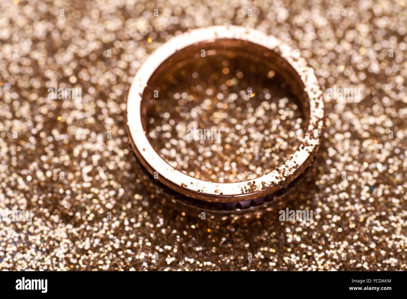 Golden ring on golden sand Stock Photo - Alamy