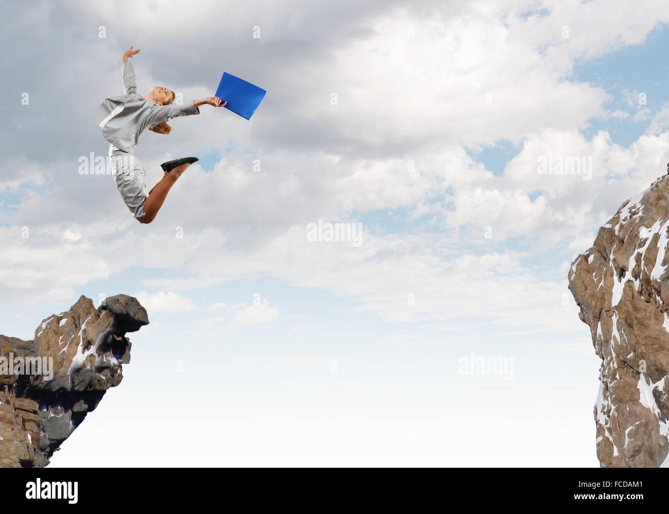 Young businesswoman jumping over gap. Risk concept Stock Photo - Alamy