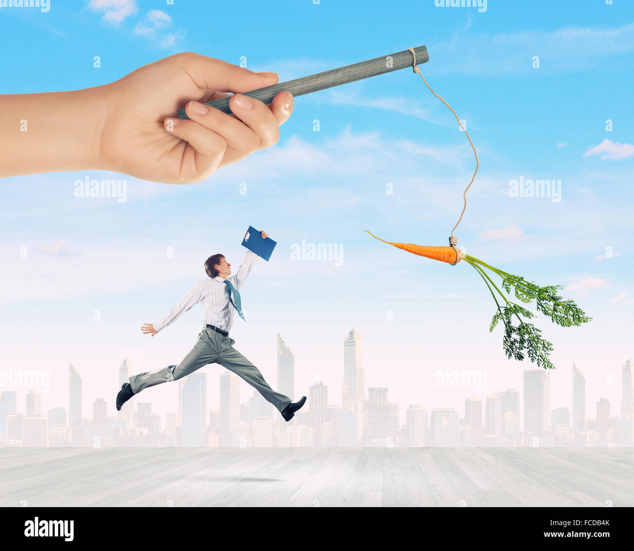 Funny image of businessman chased with carrot Stock Photo - Alamy