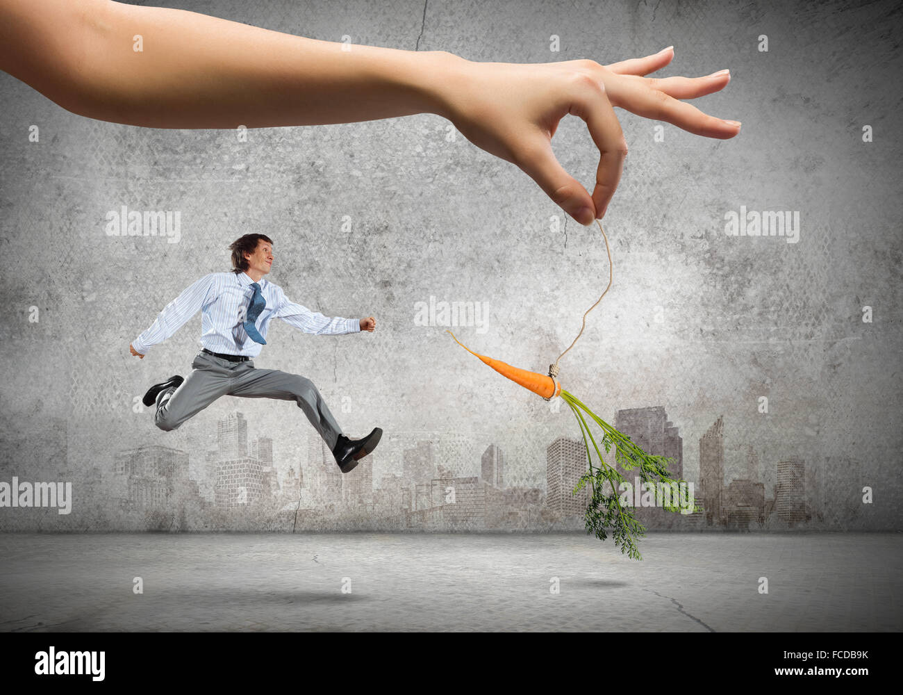Funny image of businessman chased with carrot Stock Photo - Alamy