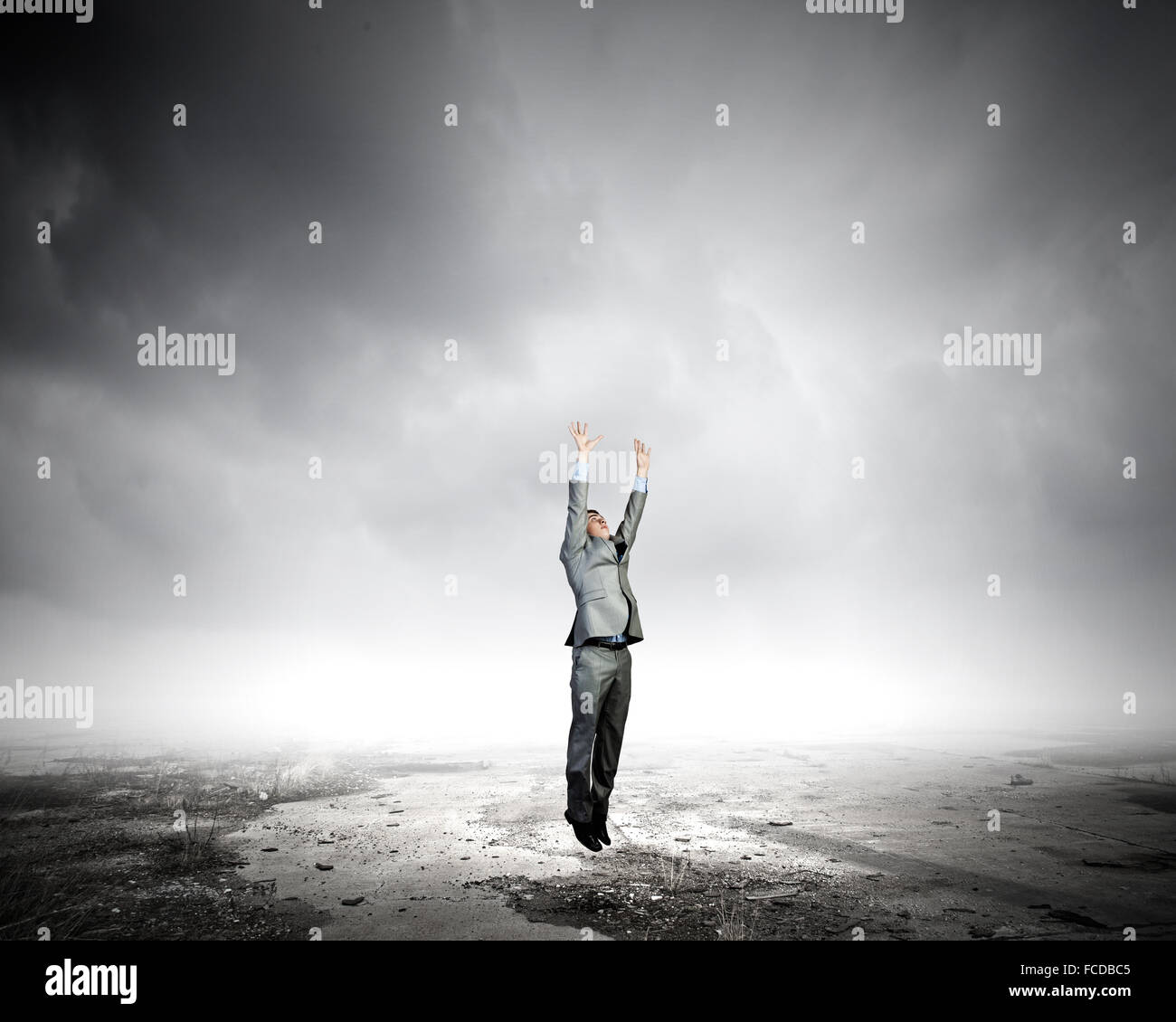Young businessman jumping up trying to reach goal Stock Photo - Alamy