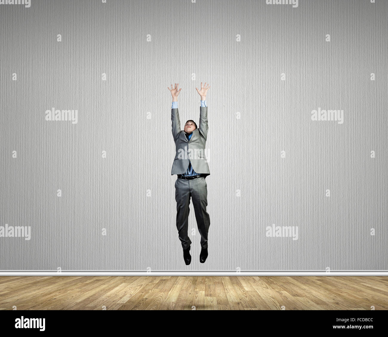 Young businessman jumping up trying to reach goal Stock Photo - Alamy