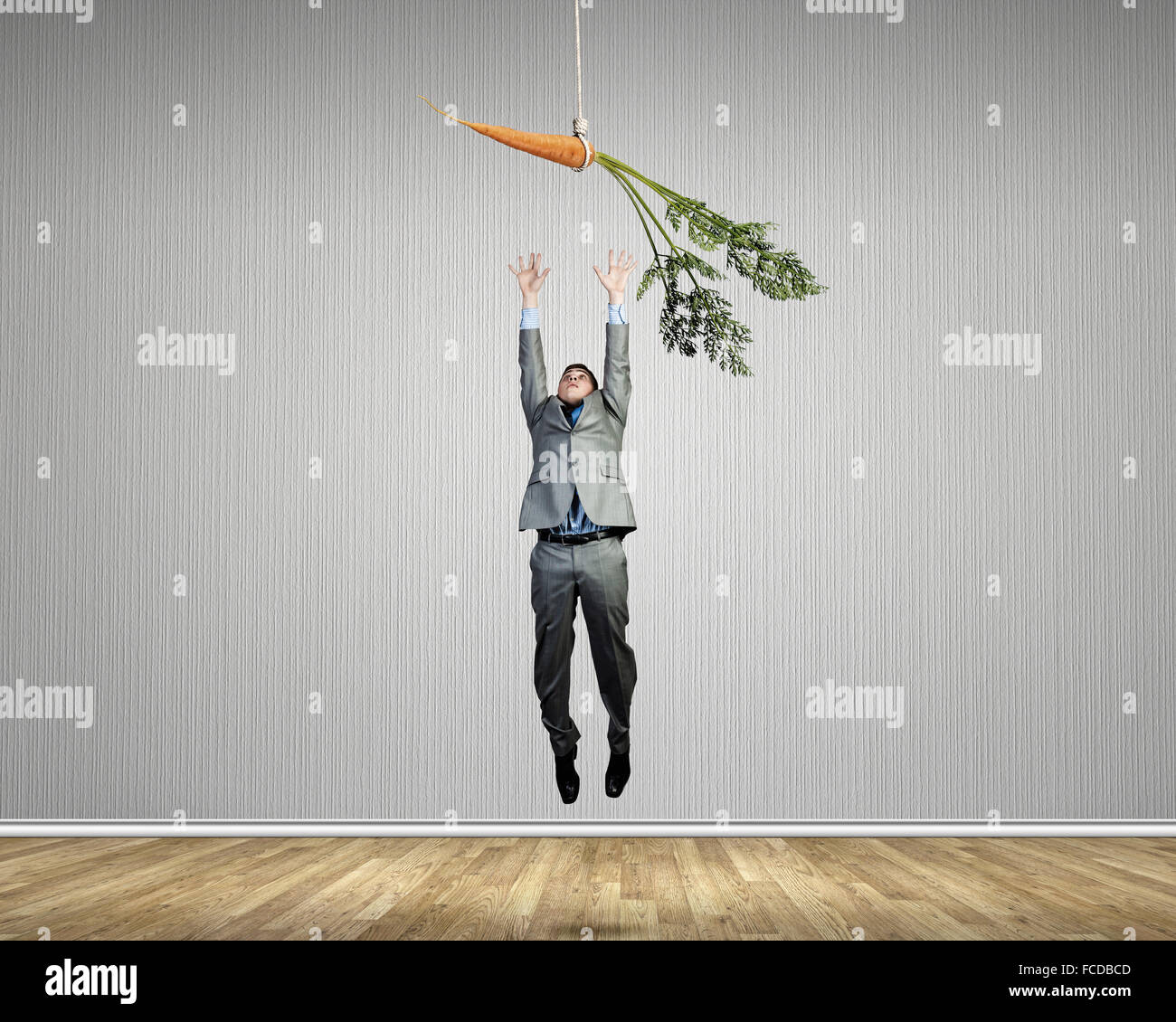 Funny image of businessman chased with carrot Stock Photo - Alamy