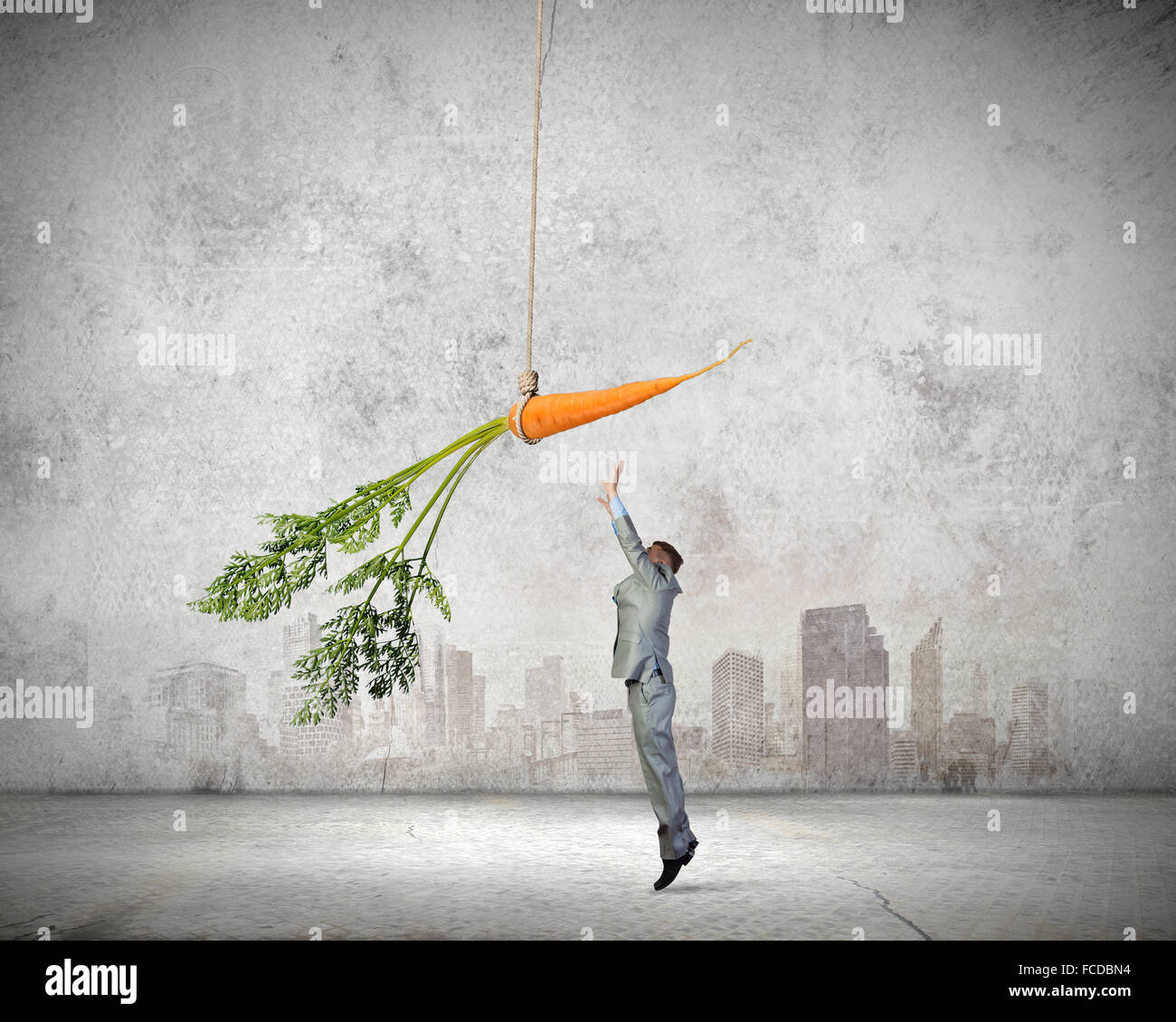 Funny image of businessman chased with carrot Stock Photo - Alamy
