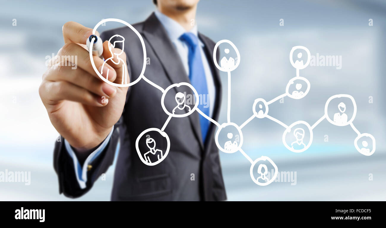 Close up of businessman drawing chain of interaction Stock Photo - Alamy
