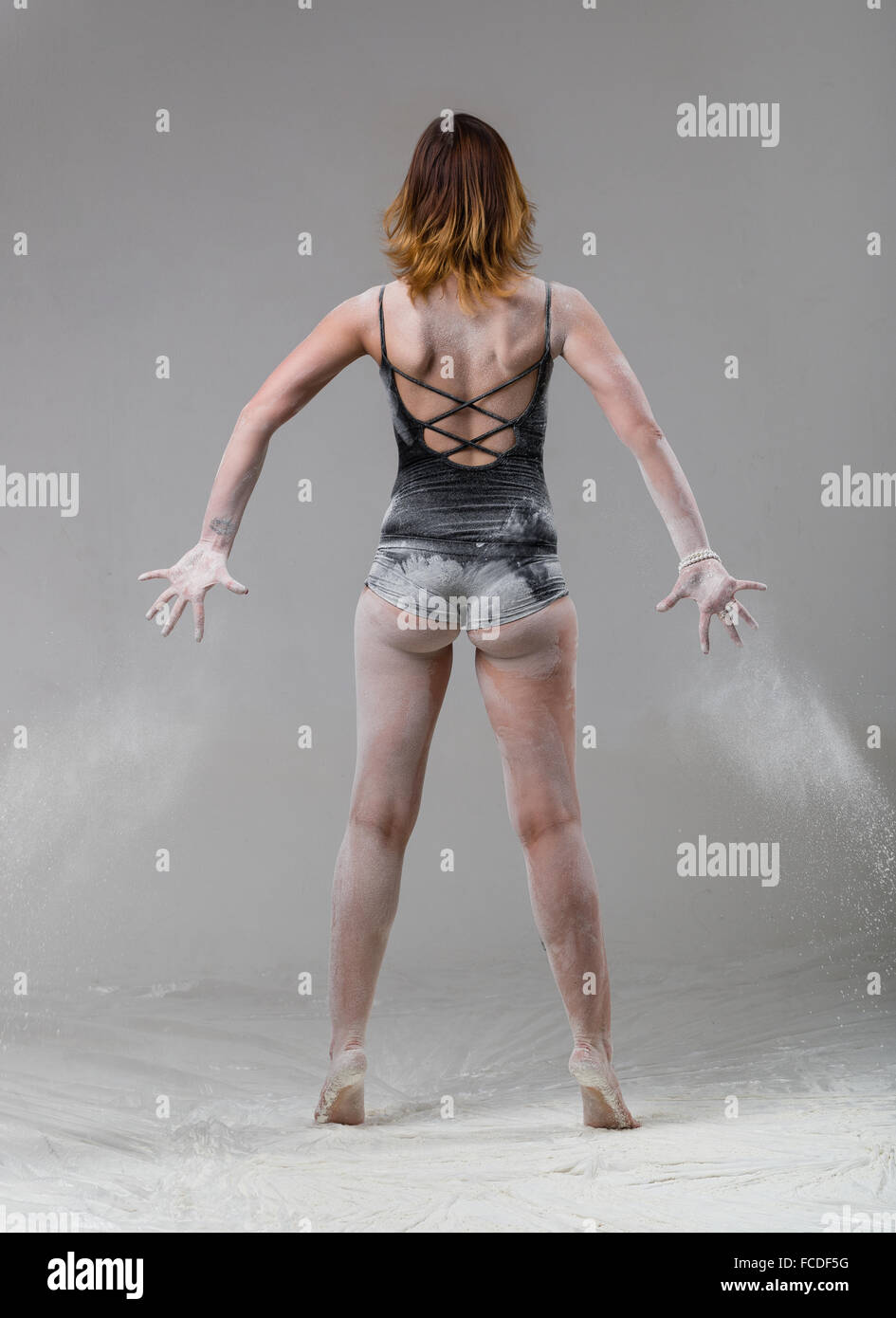 Beautiful expressive ballet dancer posing with flour at studio Stock Photo - Alamy