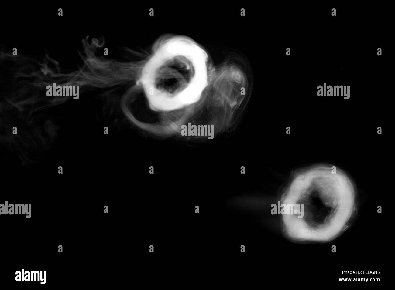 Smoke ring smoke rings Black and White Stock Photos & Images - Alamy