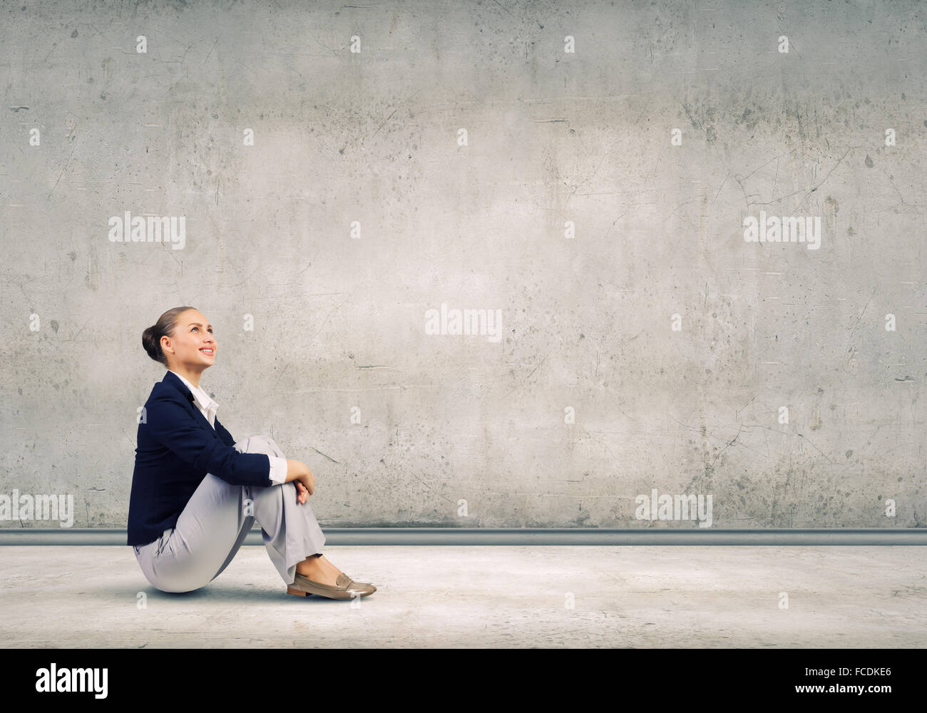 Young attractive lady sitting on floor of empty room Stock Photo - Alamy