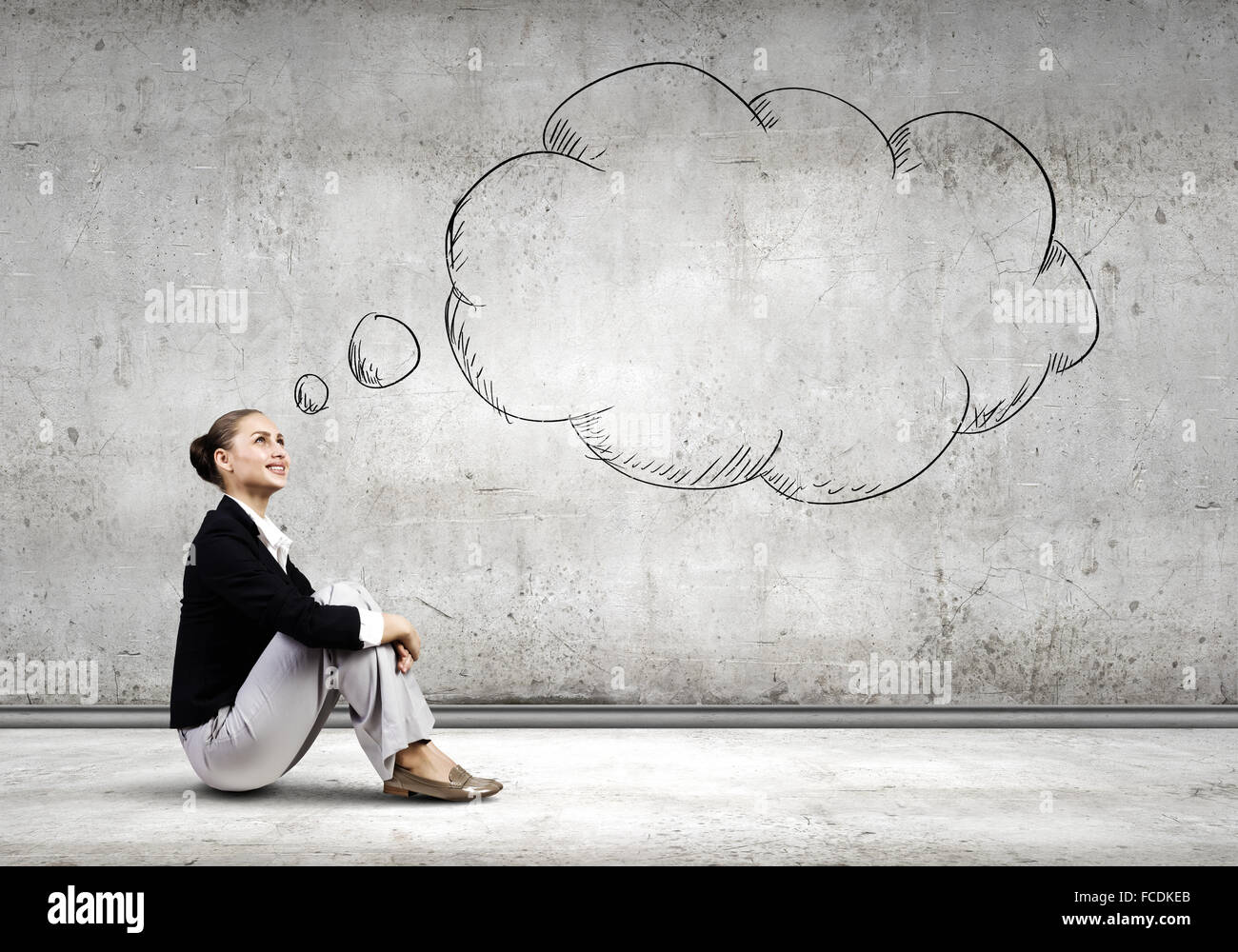 Young attractive lady sitting on floor of empty room Stock Photo - Alamy