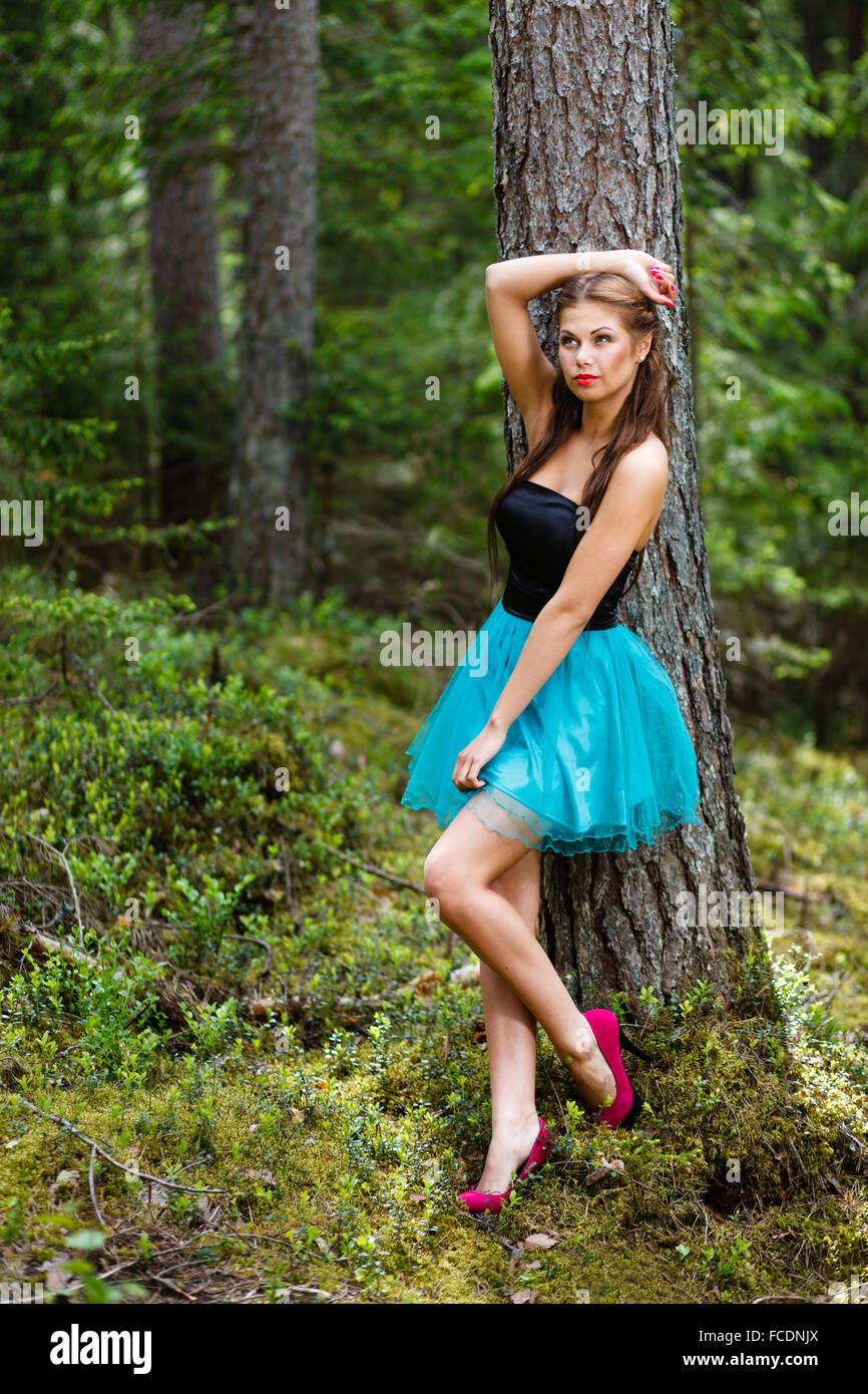 Girl standing near a tree Stock Photo - Alamy