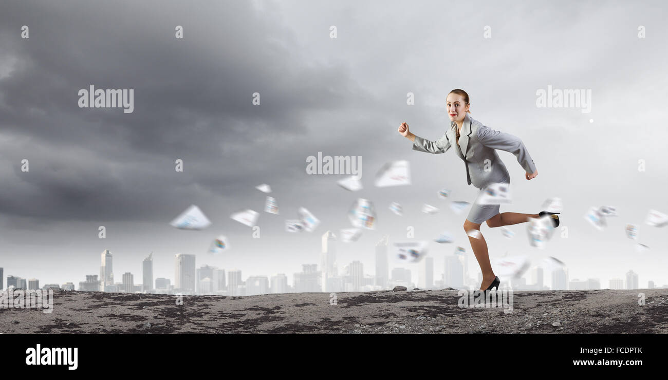 Young businesswoman in suit running in a hurry Stock Photo - Alamy