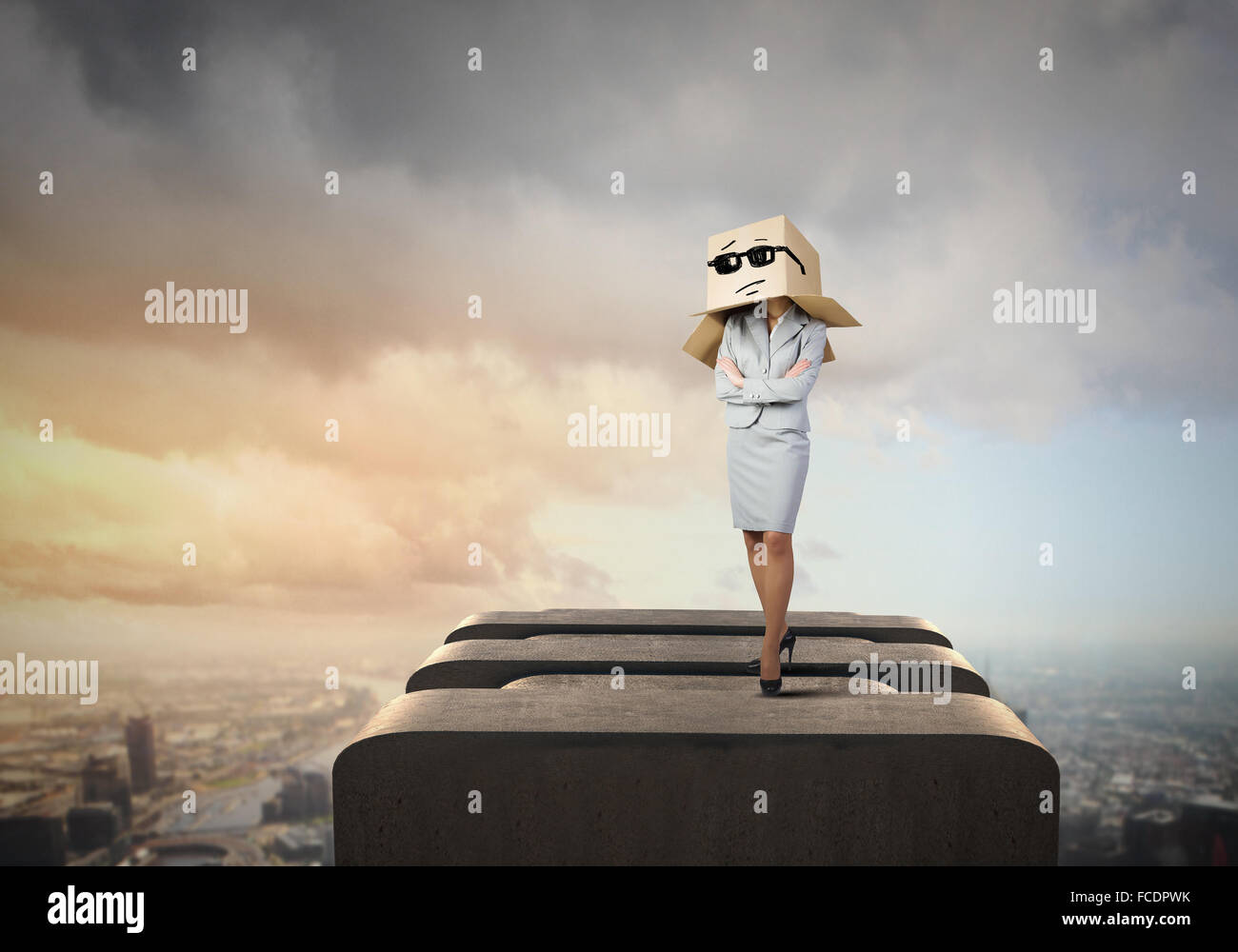 Businesswoman in suit wearing carton box on head Stock Photo - Alamy