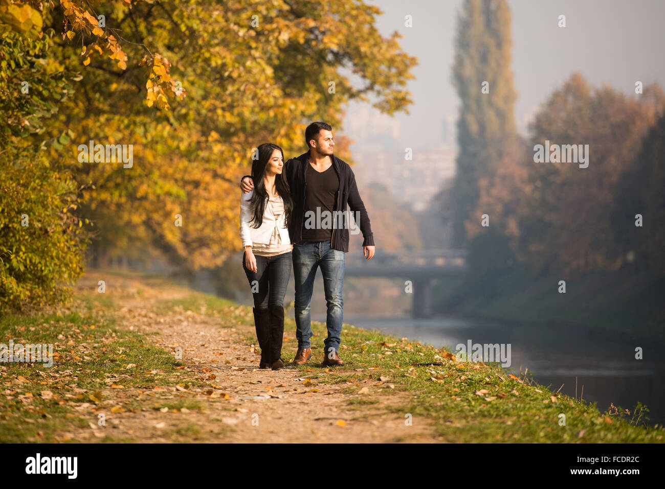Couple Walking In Forest Through The Woods Outside During Autumn Stock ...