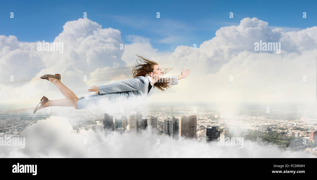 Young happy businesswoman flying high in sky Stock Photo - Alamy